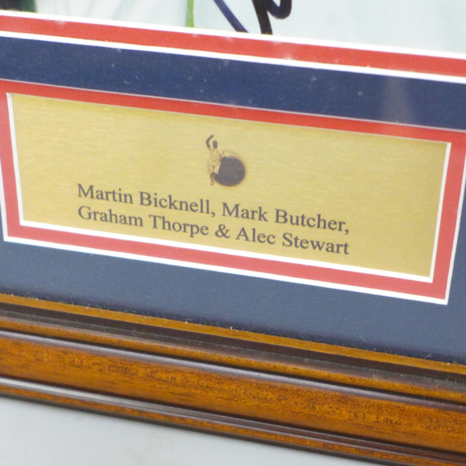 A framed and mounted picture, signed by four England players; Martin ...