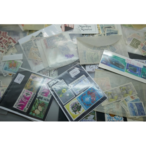 Stamps; a box of stamps on stock cards and in packets, better noticed