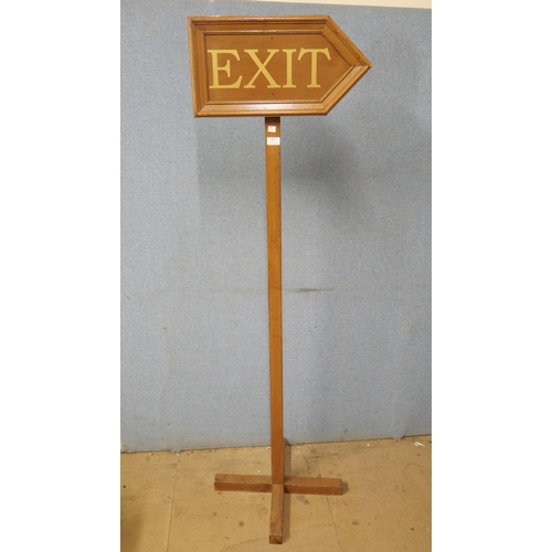 A wooden exit sign