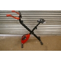 A Body Revolution exercise bike in red and black with digital monitor