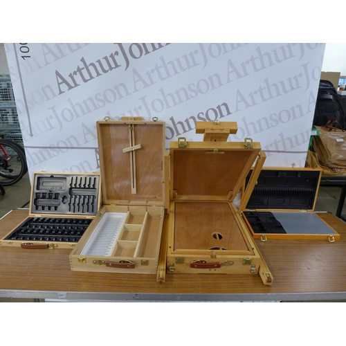 Two wooden artists easel boxes and two wooden cases