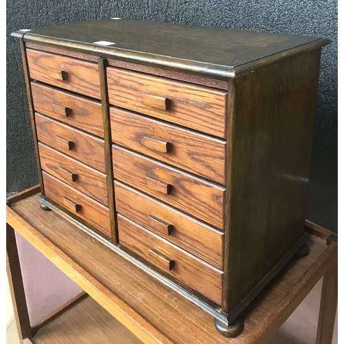 An early 20th Century oak tabletop collectors chest