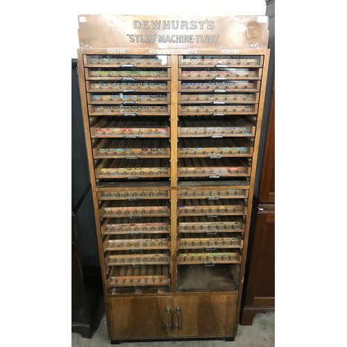A Dewhurst's Sylko Machine Twist beech and walnut haberdashery shop cabinet