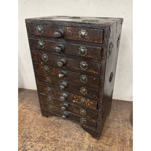 A small Chinese wooden table top chest of drawers