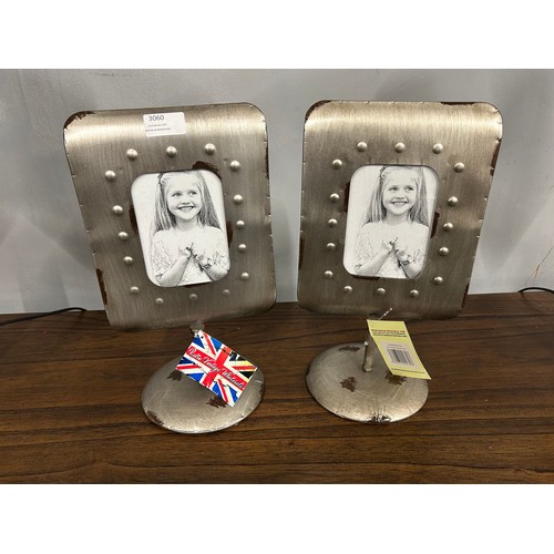 A pair of metal photo frames