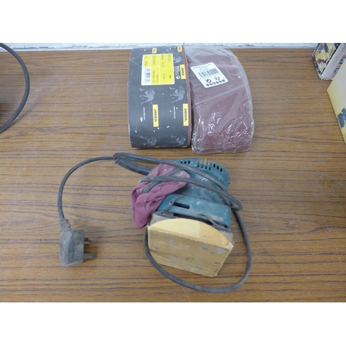 A Bosch GBS 100A belt sander and 2 packs of replacement belts with a ...