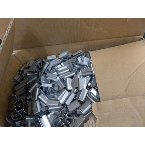 A banding machine with a box of metal clips