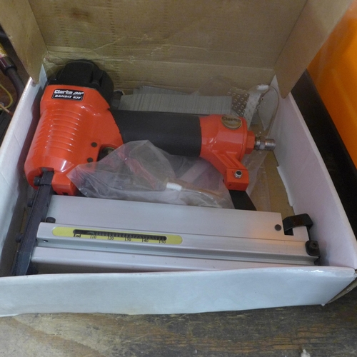 A boxed sample Clarke Air Bandit and nail gun with a quantity of nails ...