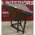 A Victorian Jacobean Revival oak gateleg corner lamp table