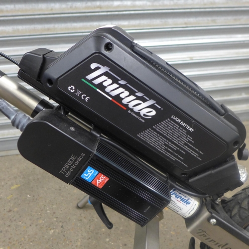 A Triride electric wheelchair attachment with Li-ion battery