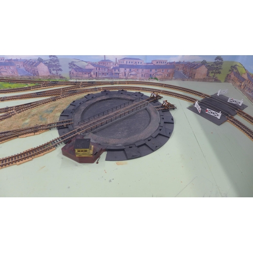 A model railway station with decorative back drop and 2 boxes of ...