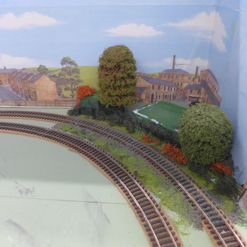 A model railway station with decorative back drop and 2 boxes of ...