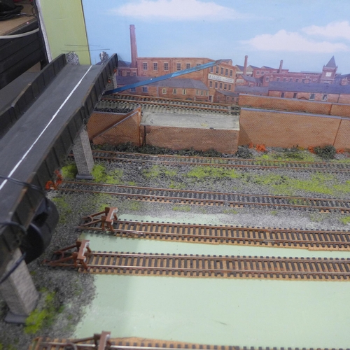 A model railway station with decorative back drop and 2 boxes of ...