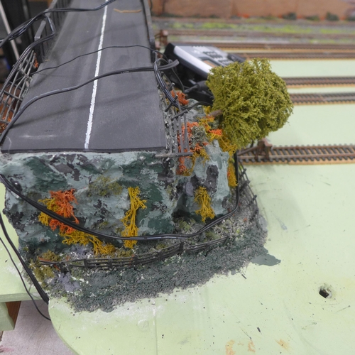 A model railway station with decorative back drop and 2 boxes of ...