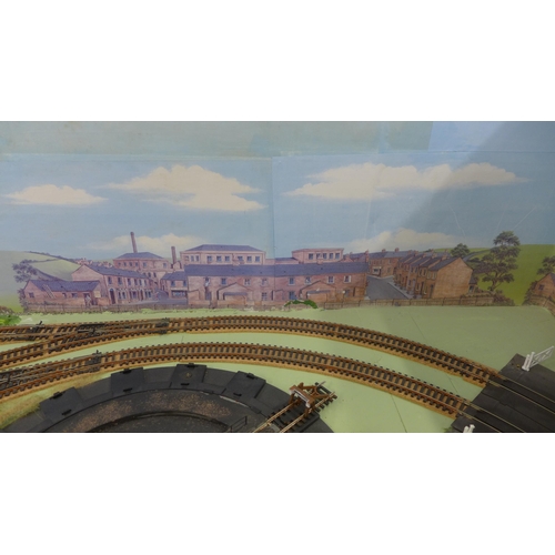 A model railway station with decorative back drop and 2 boxes of ...