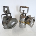 An LNER carbide handheld lamp, partially restored and one other unrestored.