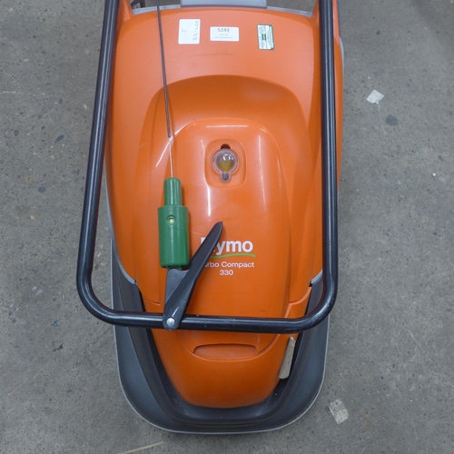 A Flymo Turbo Compact 330 electric mower and a Scott lawn seed spreader