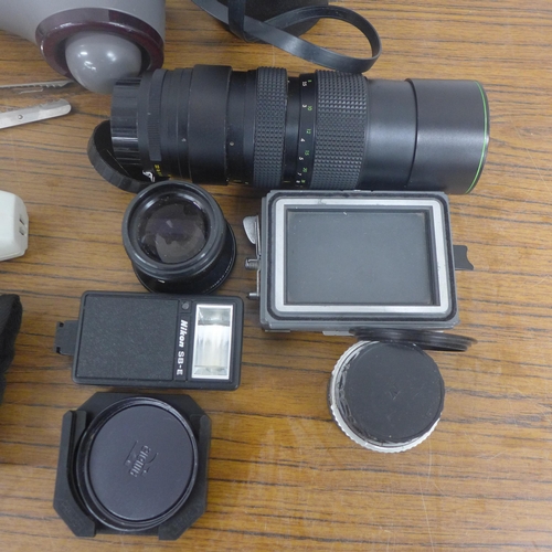 Assorted camera lenses and other camera equipment with assorted kitchen ...