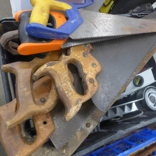 An assortment of mixed tools including hammers, saws, chisels, etc.