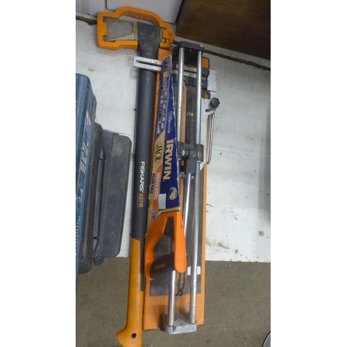 A manual tile saw, a Fiskars X27 axe and an Irwin universal plus 880 saw