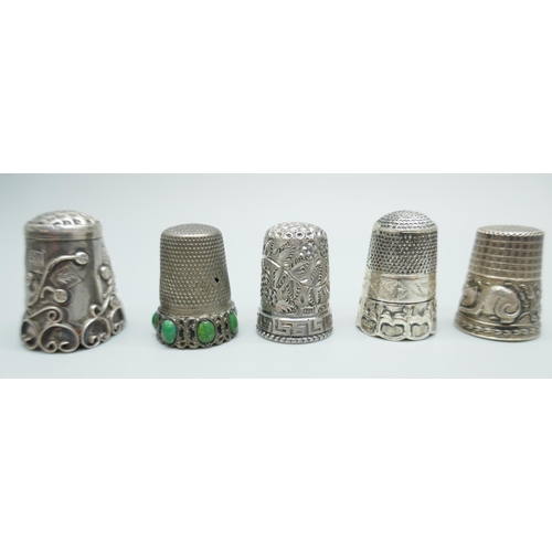 Four silver thimbles and a white metal thimble with turquoise cabochons ...