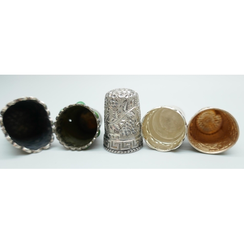 Four silver thimbles and a white metal thimble with turquoise cabochons ...