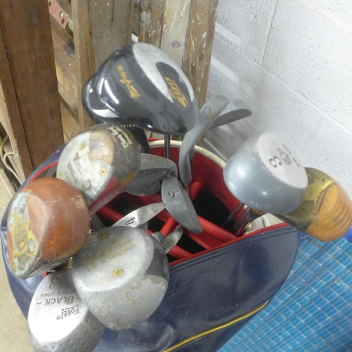 A golf bag and various golf clubs including Fore black ridge series 3 ...