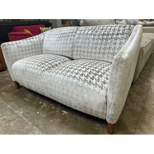 A patterned velvet 2 seater sofa