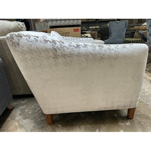 A patterned velvet 2 seater sofa