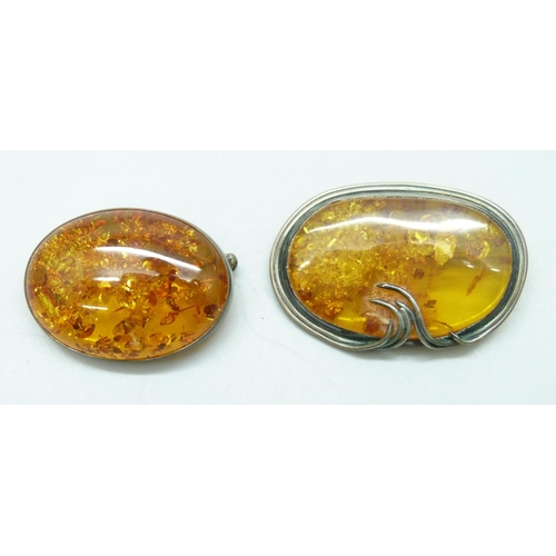 Two silver and amber brooches, largest 4.4cm