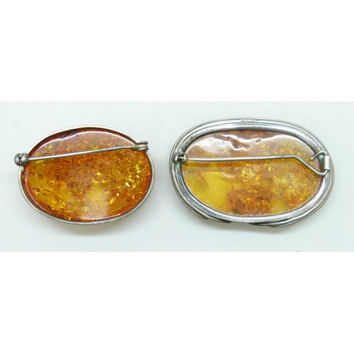 Two silver and amber brooches, largest 4.4cm