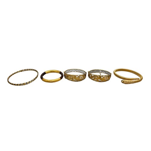 Four gilt metal bangles, including one in the form of a snake, and a high carat yellow metal mounted