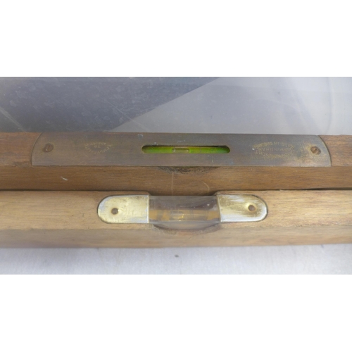 A box of assorted wooden planes and wooden spirit levels