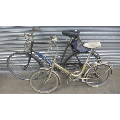 A Triumph gents push bike and a Phillips folding ladies bicycle