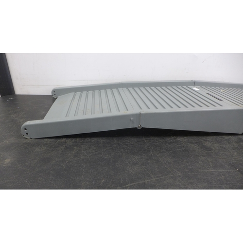 A Tikatak extendable knee kicker - boxed and a plastic folding ramp