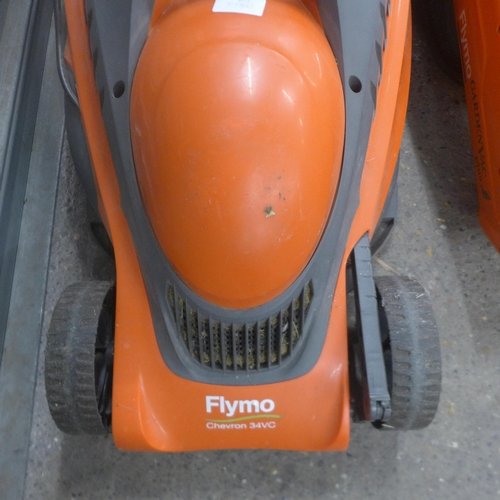 A Flymo Chevron 34vc electric lawnmower and a Flymo garden vac plus ...