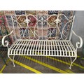 A white metal garden bench