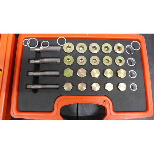 A cased oil drain plug thread repair kit and a cased MacPherson spring ...