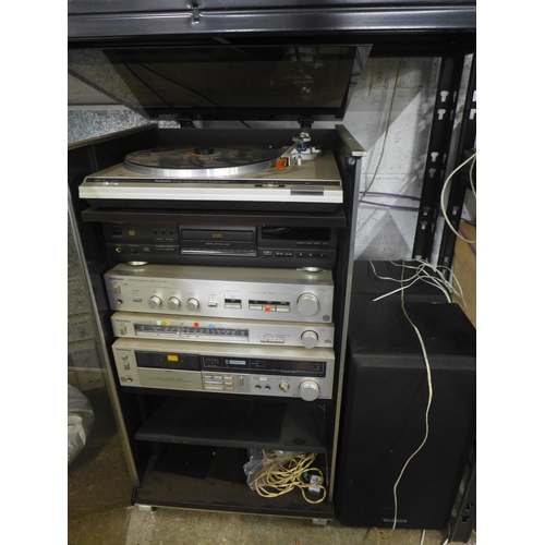 A quantity of Technics stereo separates in a wooden display cabinet ...