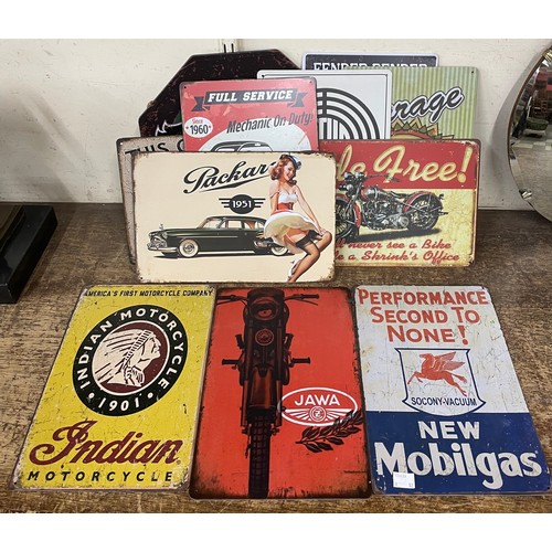 Twelve motoring related tin signs