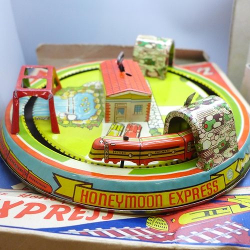 Two tin-plate toys, a Louis Marx Honeymoon Express and a Gescha B720 ...