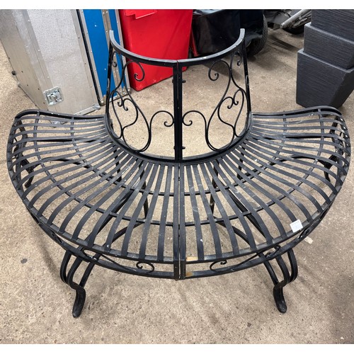 A tree surround cast iron bench
