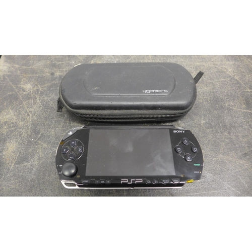 A Plano black PSP-1003 portable handheld games console with charging ...