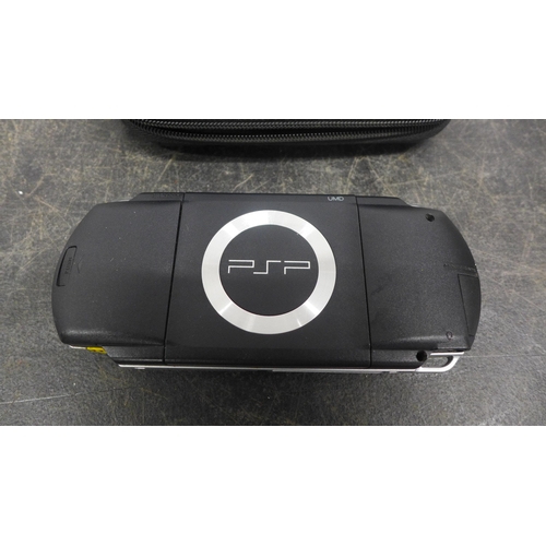 A Plano black PSP-1003 portable handheld games console with charging ...