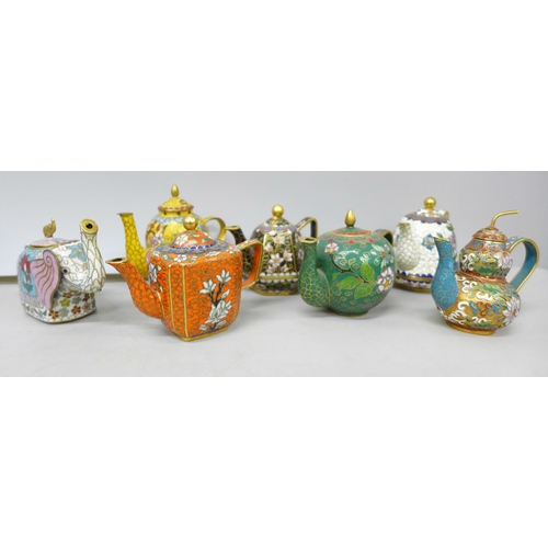 A collection of seven small cloisonne teapots including one in the ...