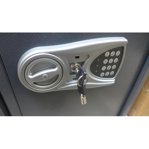 A floor standing digital combination safe, with keys ** This lot is ...