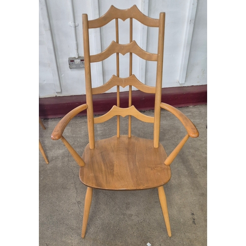 A set of four Ercol Blonde elm and beech 496 model batwing dining chairs