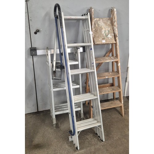 A 5 rung wooden step ladder, a 5 rung aluminum triple extending ladder ...