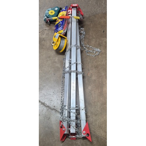 A hoist tressel with a harness and hand winch