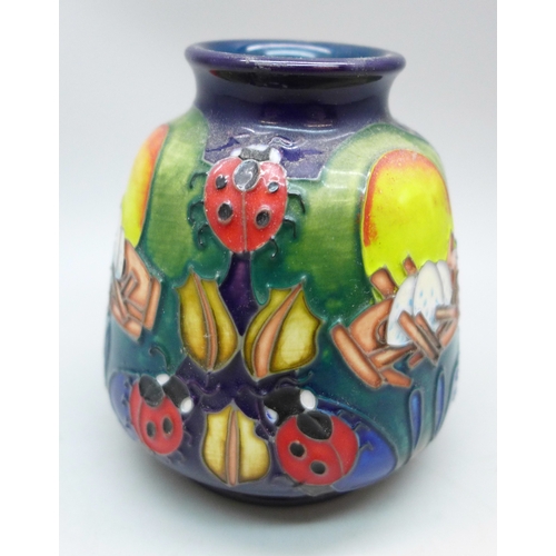 A Moorcroft pottery ladybug and bird nest pattern vase, designed by ...